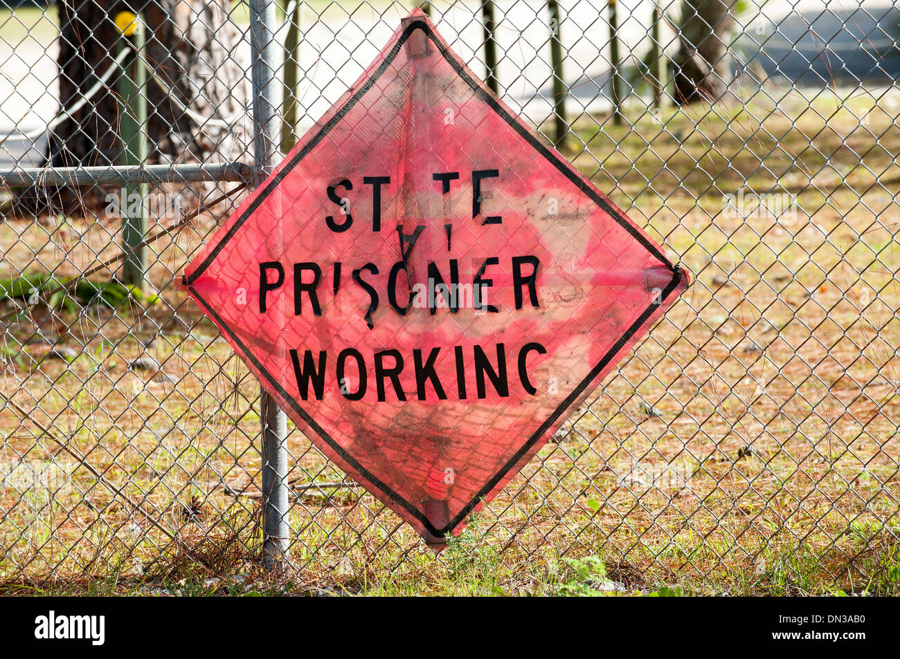 State prison. Prisoners working sign on prison security fence. USA ...