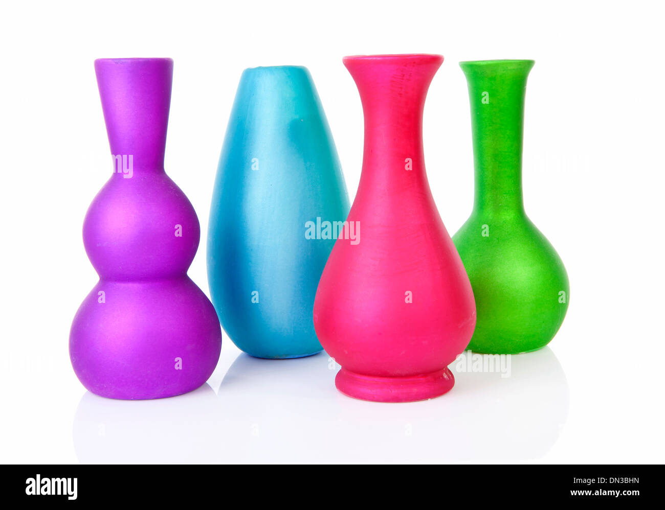 Four colorful empty vases over white background Stock Photo - Alamy