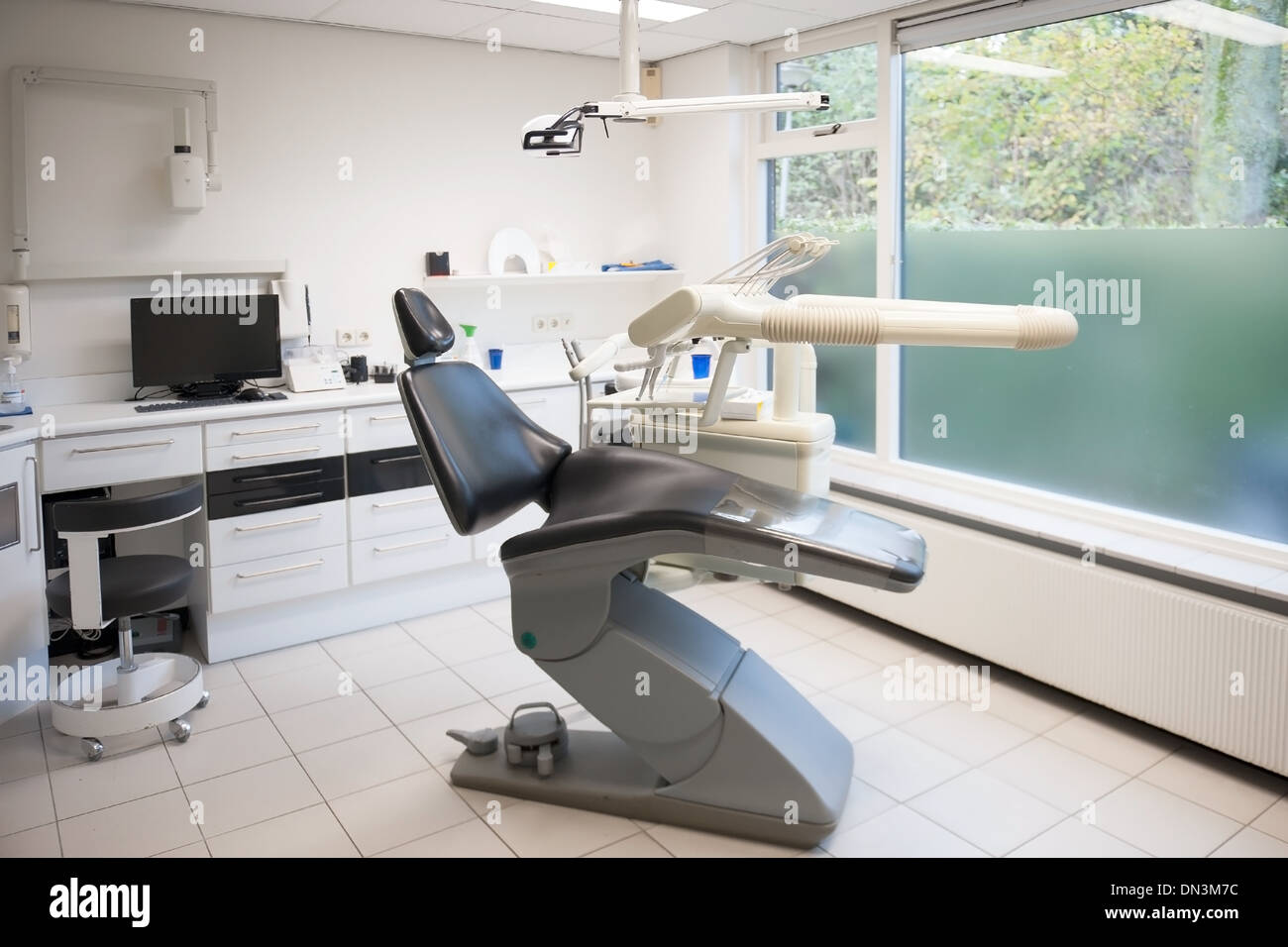 a consulting room in a dental practice, with a chair, instruments and a ...