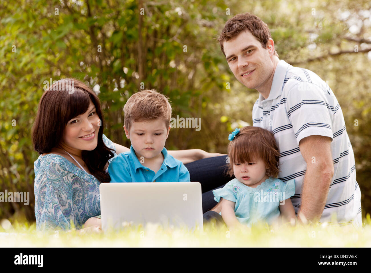 Outdoor Family with Computer Stock Photo - Alamy