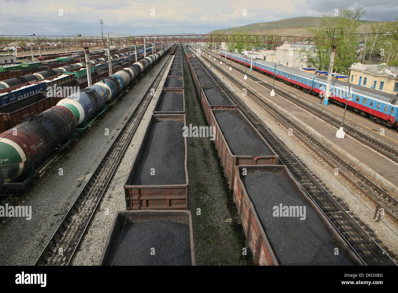 Russian freight train cars in a freight yard alomngside a passenger ...