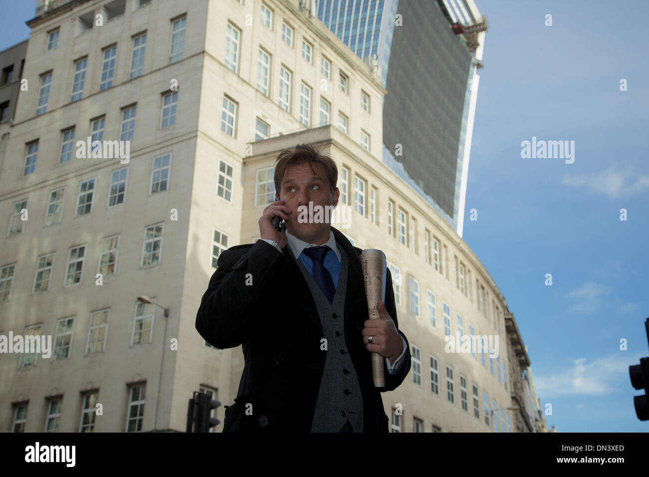 A City of London businessman speaking on his mobile phone with the ...