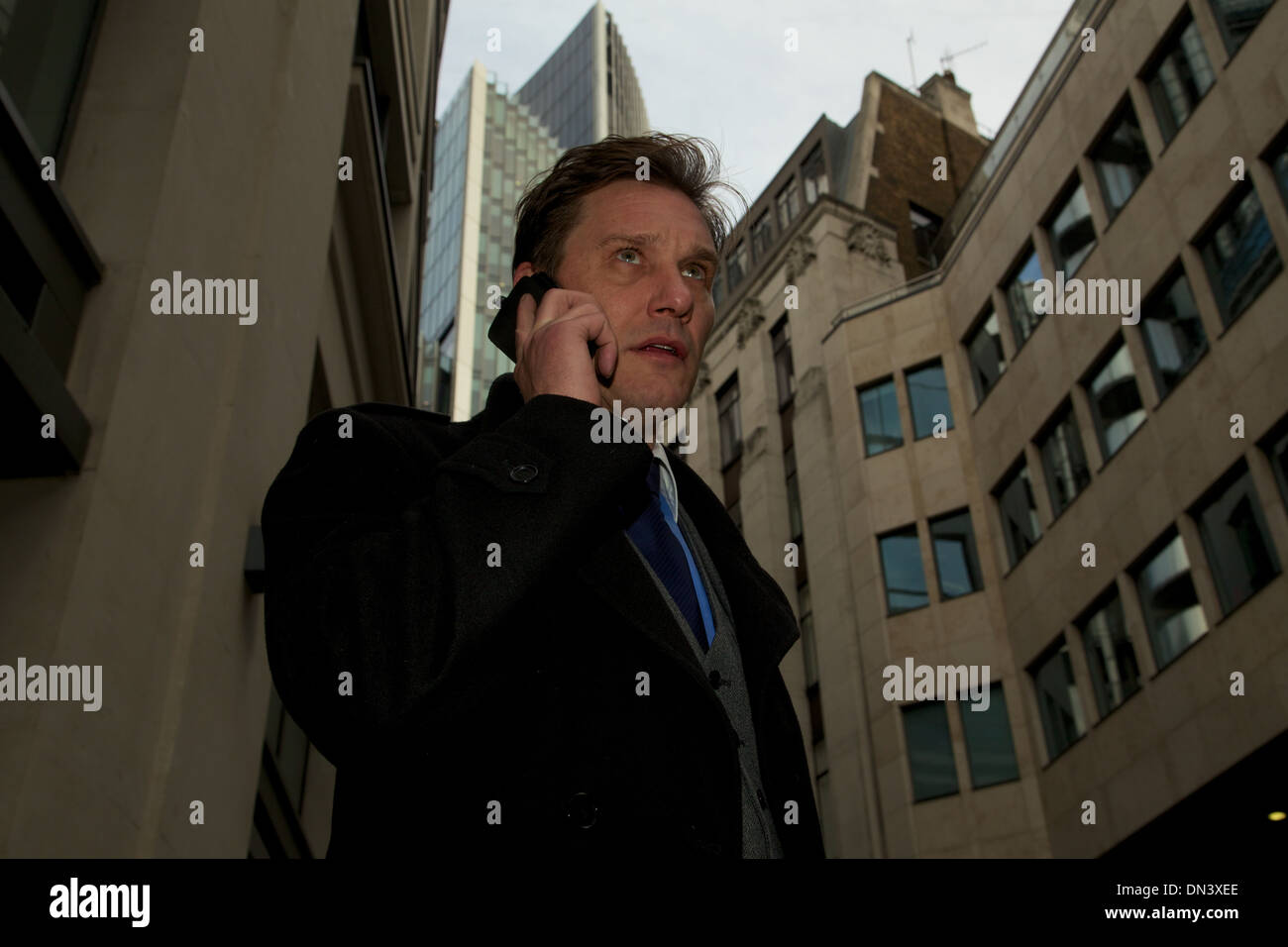 A City of London businessman speaking on his mobile phone, looking ...