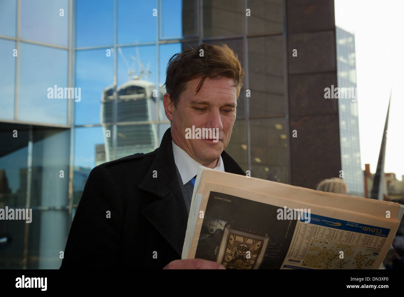 A City of London businessman reading the Financial Times, smiling with ...