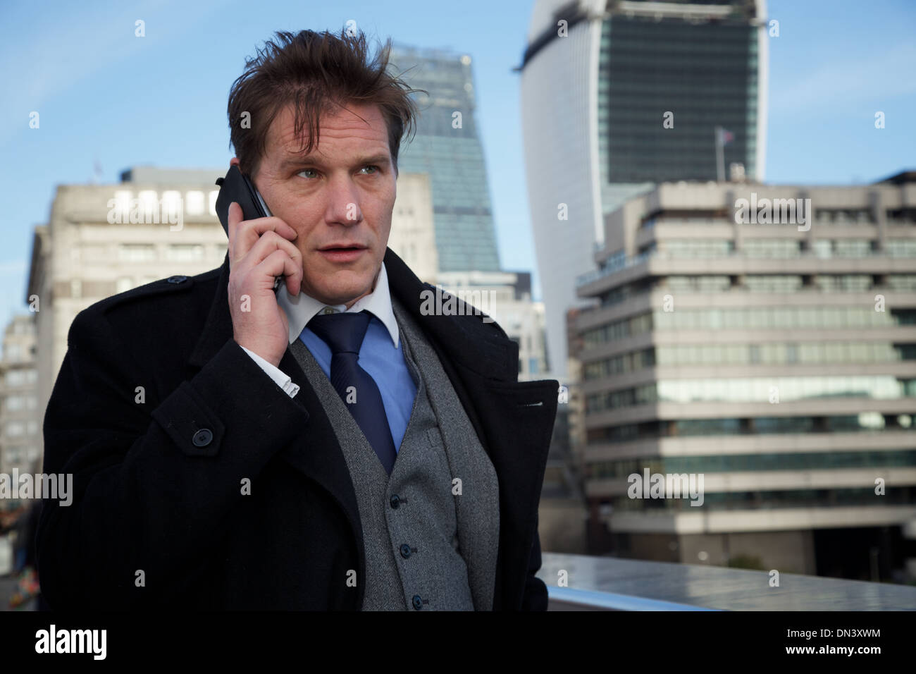 A City of London businessman speaking on his mobile phone with the ...