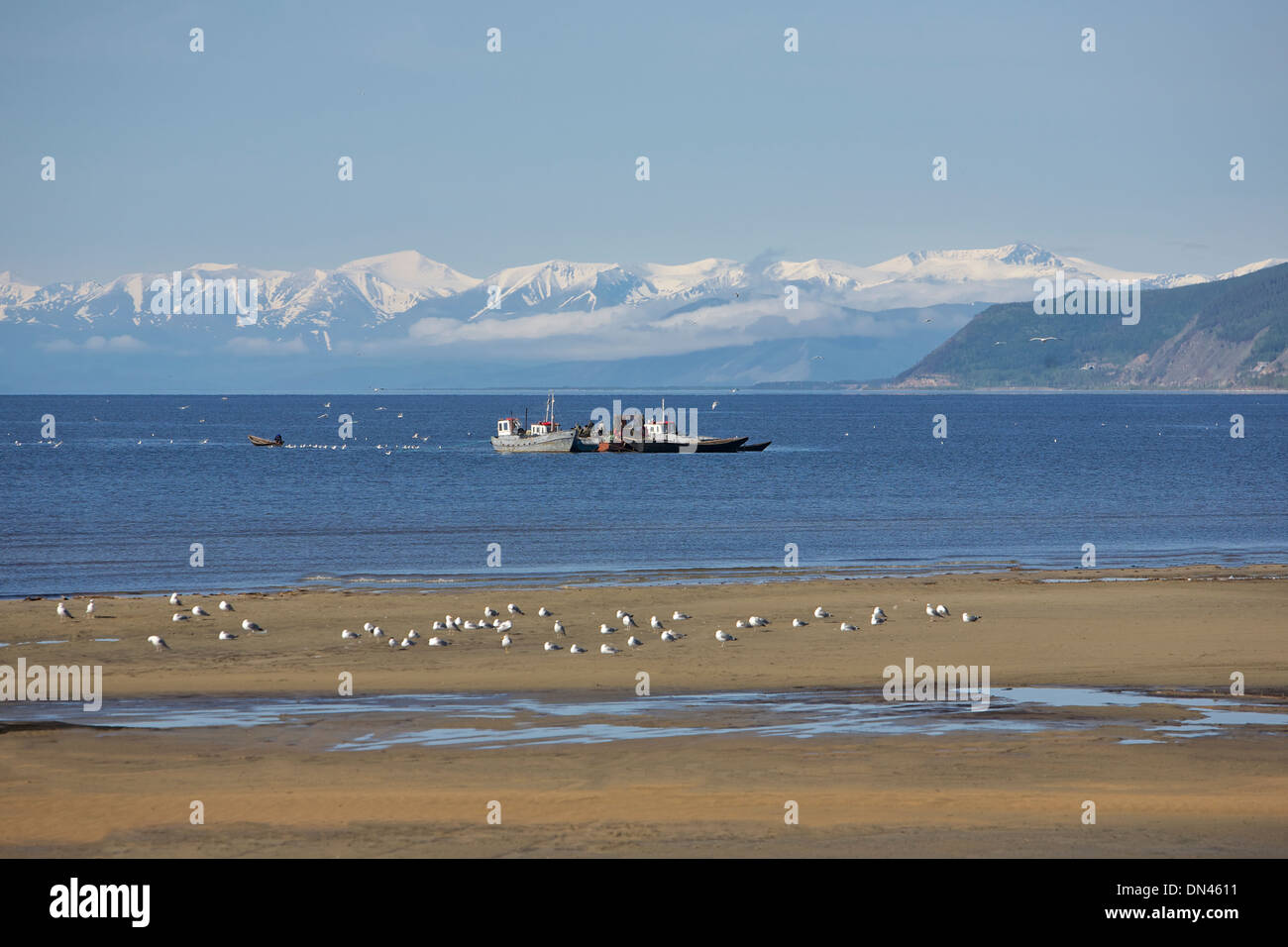 The Baikal mountains are seen behind fishing boats off Severobaykalsk ...