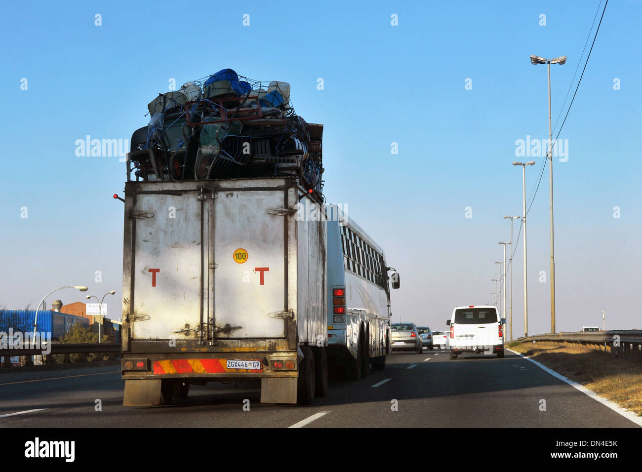 A bus pulling a heavily loaded trailer on a South African highway in ...