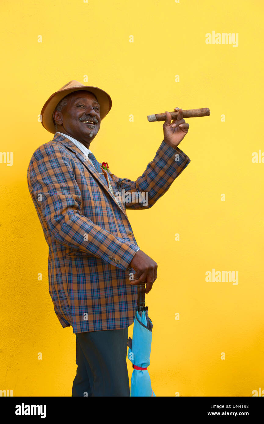 Man of color black smiling holds cigar in hand umbrella plaid jacket ...