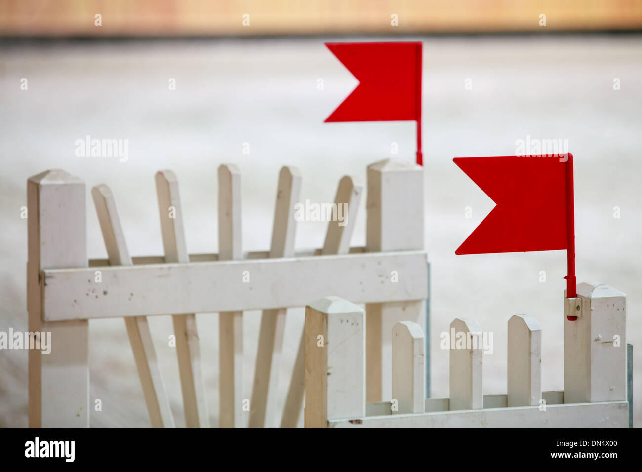 Equitation. Closeup of white obstacle with red flag for jumping horses ...