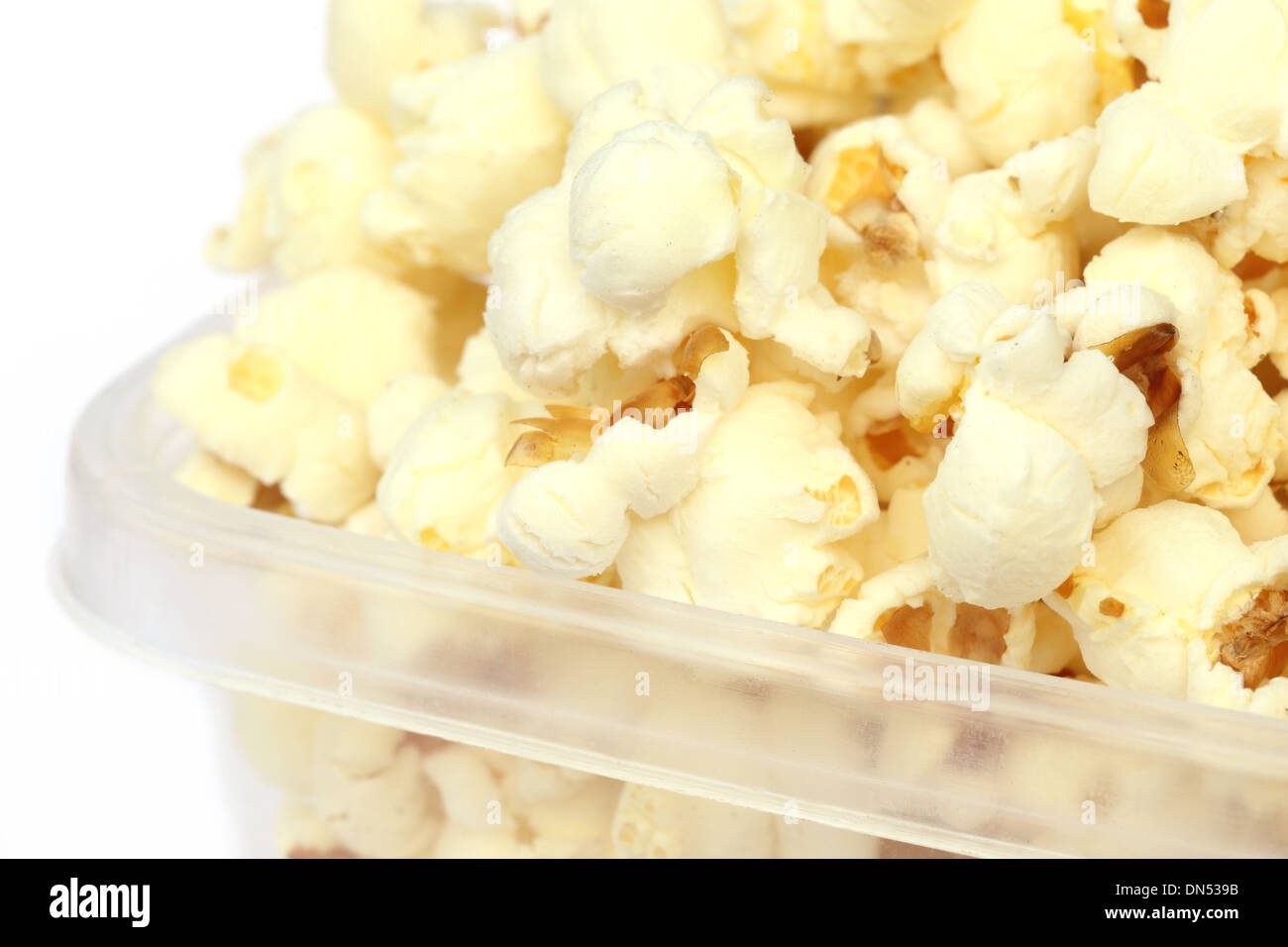 Popcorns on plastic bowl over white background Stock Photo - Alamy