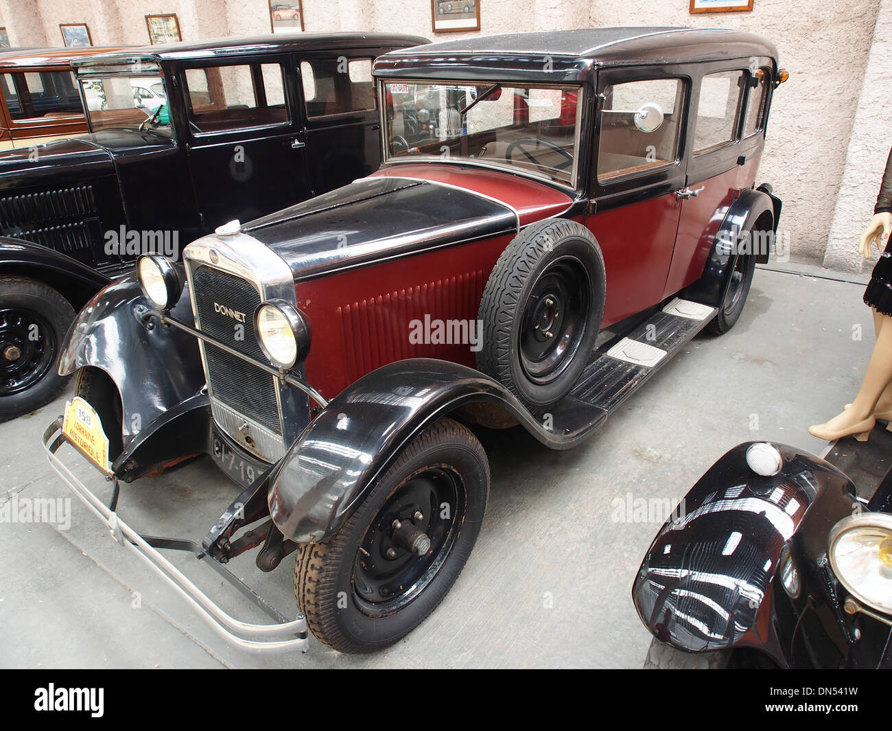 The Donnet is a vintage vehicle featuring a distinctive red and black ...