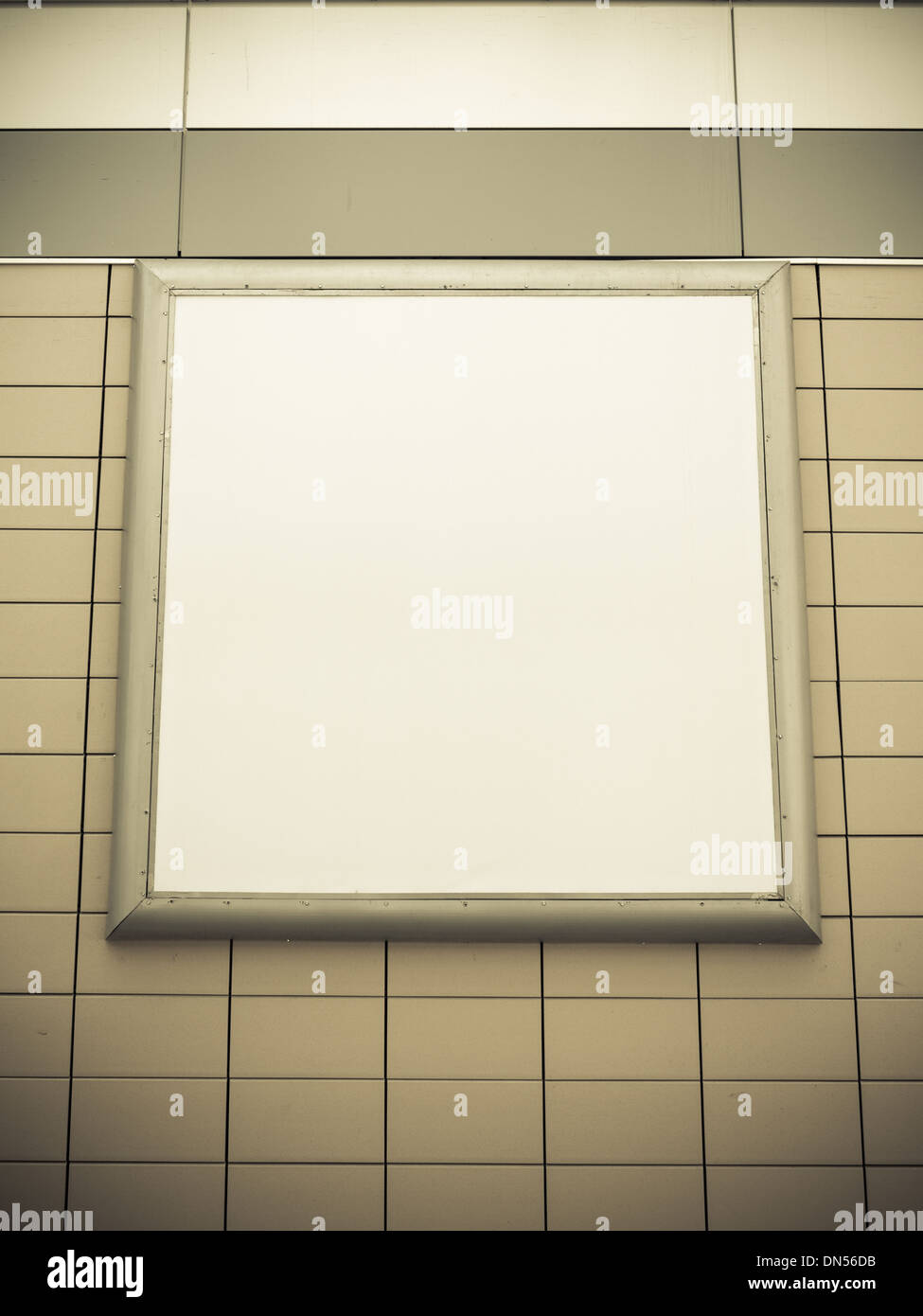 Empty blank square white advertising billboard on tiled wall ...