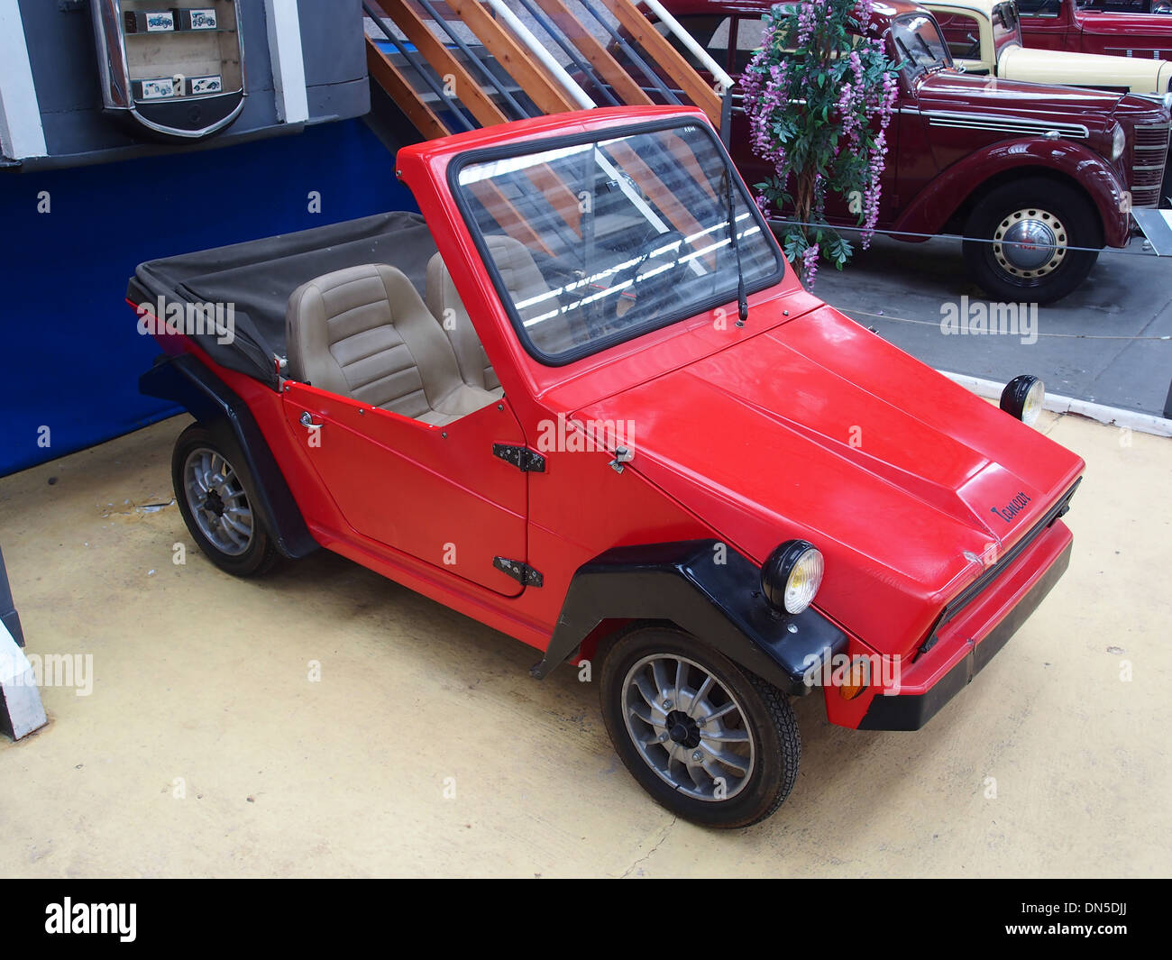 The red Tomcar is a utility vehicle known for its off-road capabilities ...