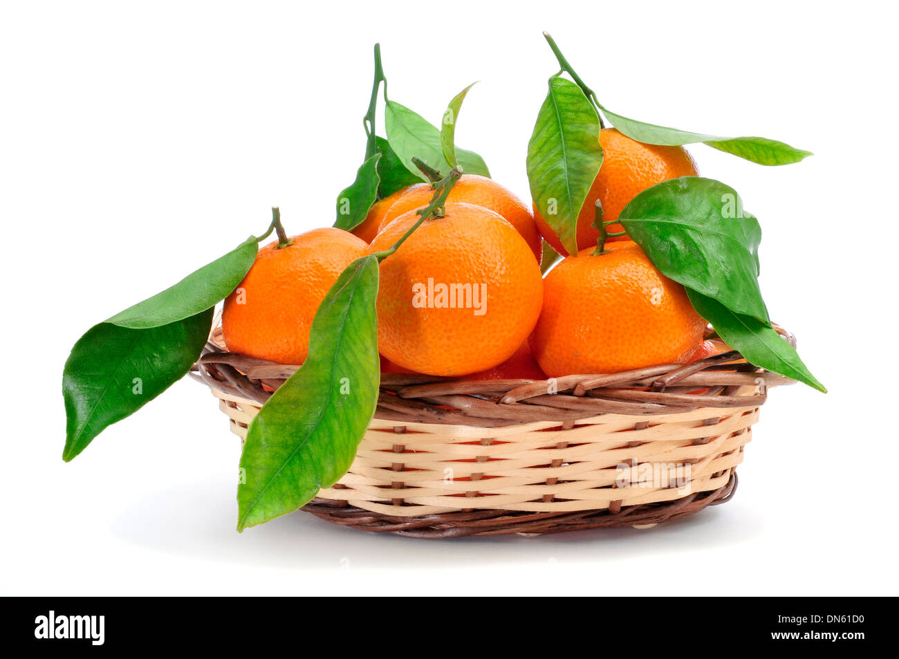 some mandarin oranges in a basket on a white background Stock Photo - Alamy
