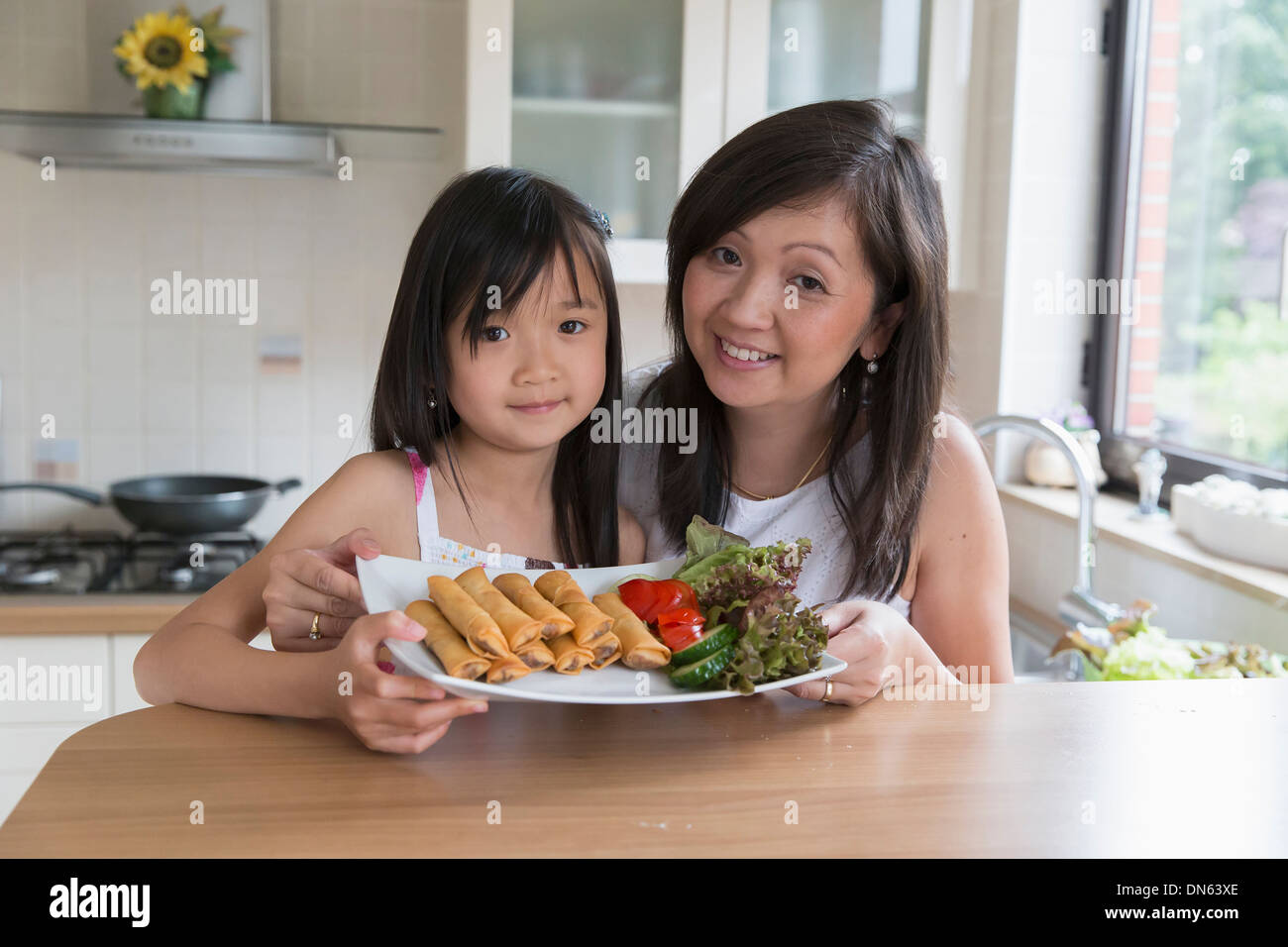 Asian mother and daughter cooking together Stock Photo - Alamy