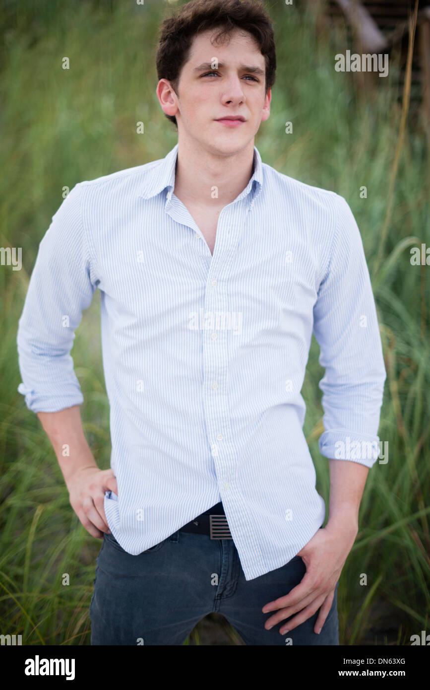 Hispanic man standing in tall grass Stock Photo - Alamy