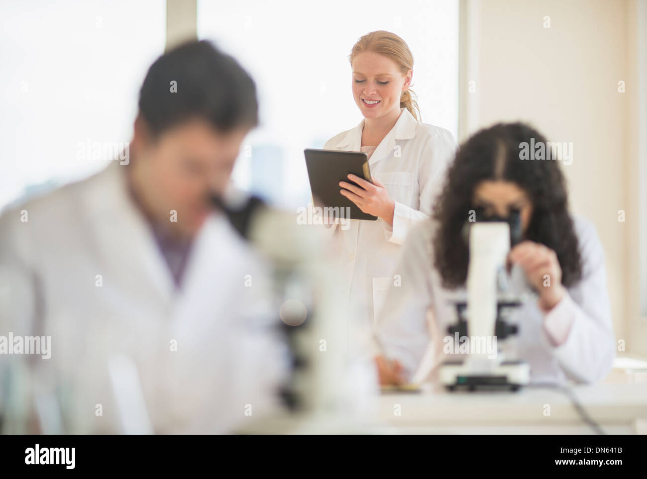 Group smiling scientists examining hi-res stock photography and images ...
