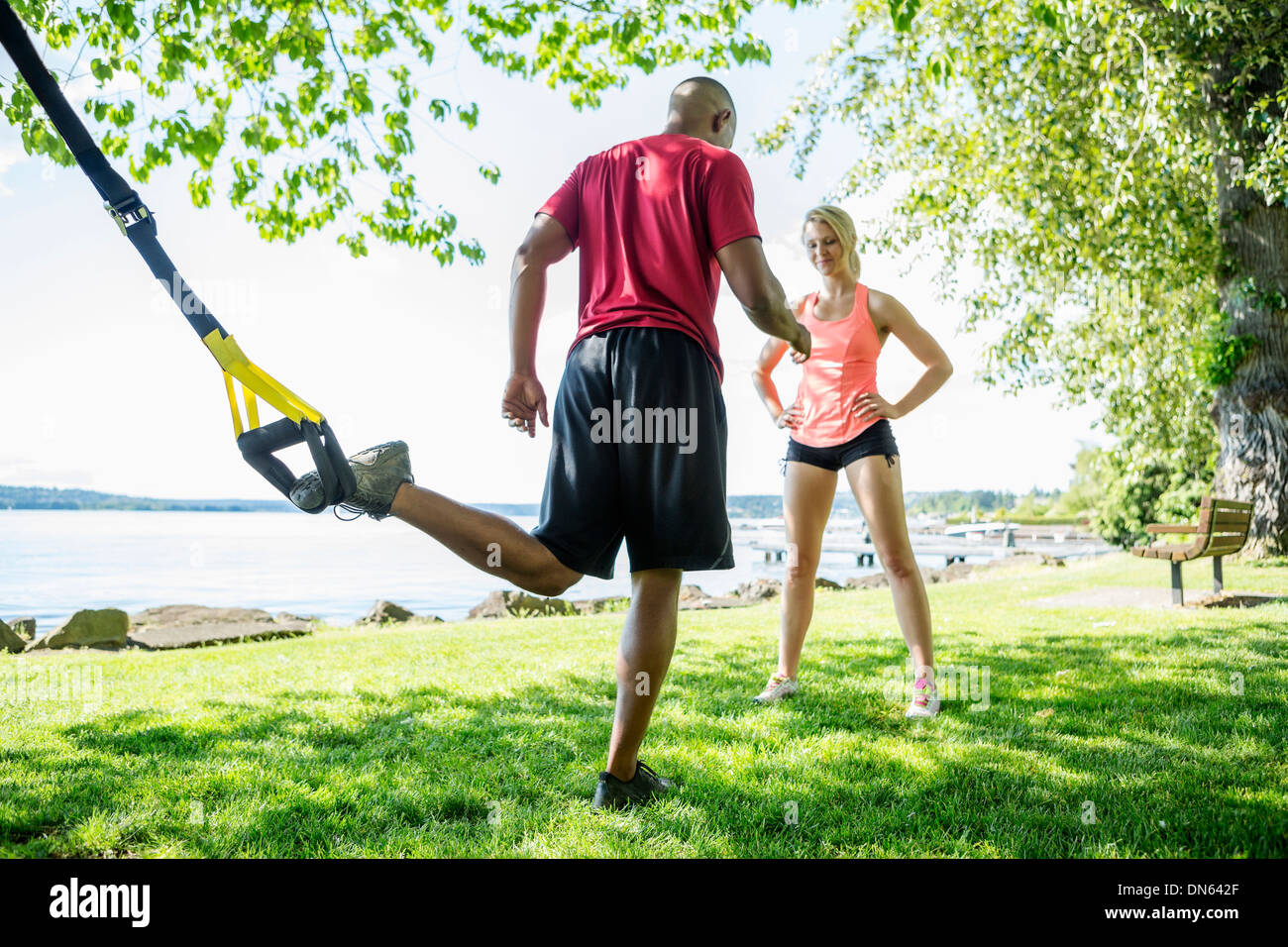 Trainer watching man working out hi-res stock photography and images ...