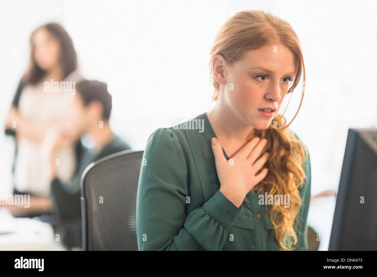 Businesswoman gasping at computer in office Stock Photo - Alamy