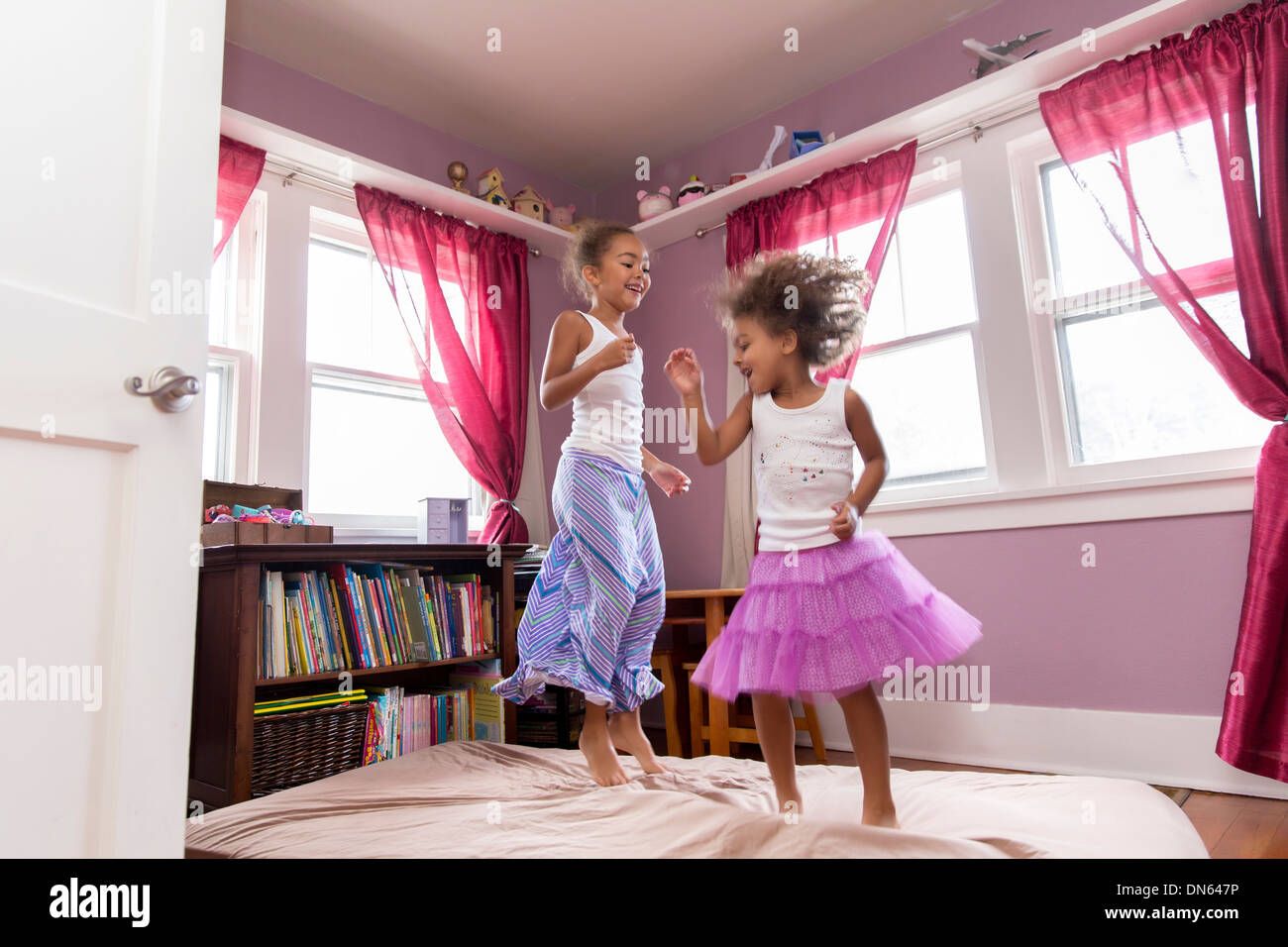 Three girls jumping on bed hi-res stock photography and images - Alamy