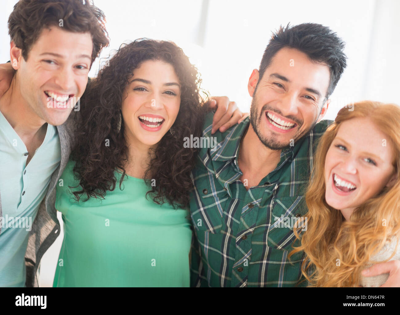 Friends laughing together Stock Photo - Alamy
