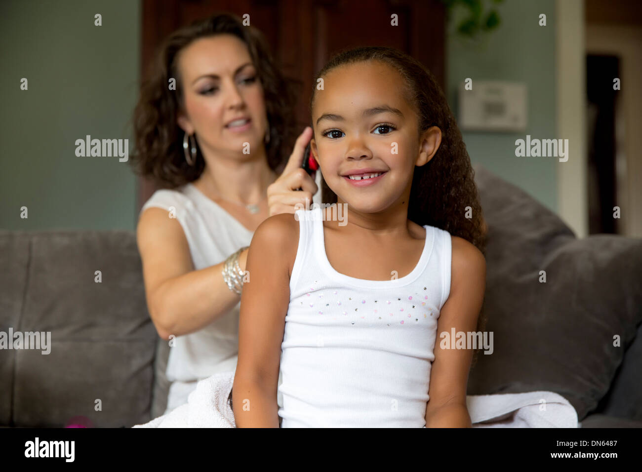 Mother fixing daughter's hair Stock Photo - Alamy