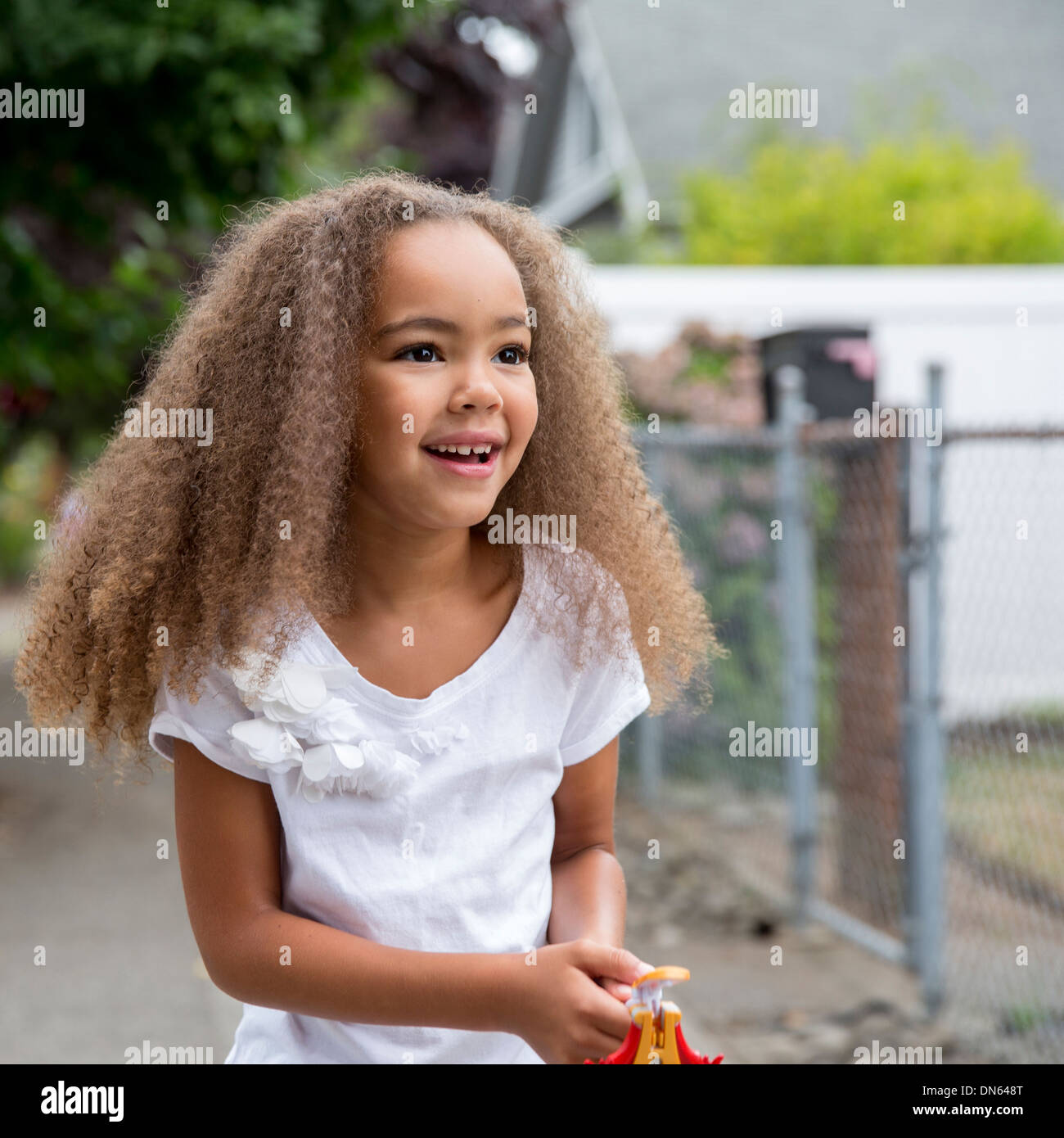 Mixed race girl walking outdoors Stock Photo - Alamy