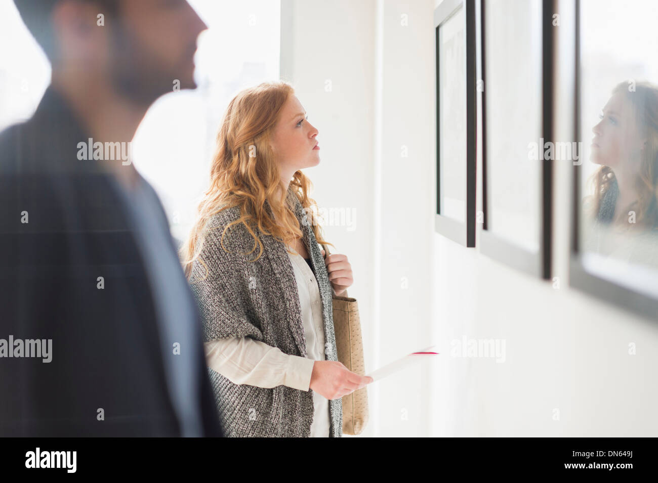 Woman admiring art in gallery Stock Photo - Alamy
