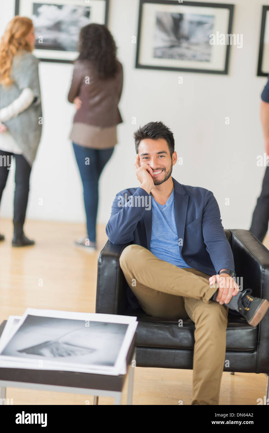 Artist smiling in art gallery Stock Photo - Alamy