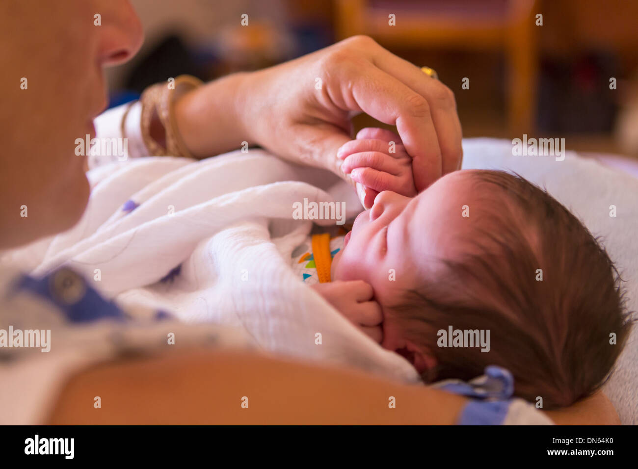 Caucasian mother holding newborn baby Stock Photo - Alamy