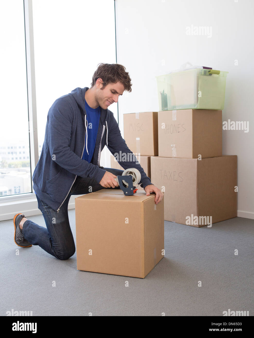 Caucasian man taping cardboard box hi-res stock photography and images ...