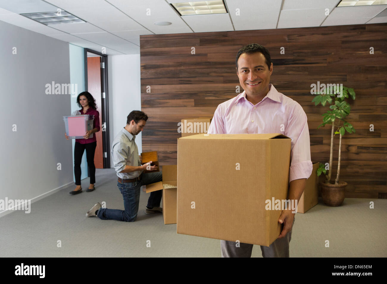 Hispanic businessman carrying cardboard box in office Stock Photo - Alamy