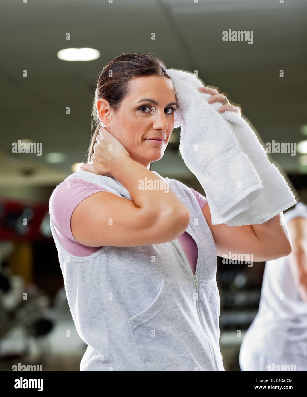 Woman Wiping Sweat With Towel At Health Club Stock Photo - Alamy