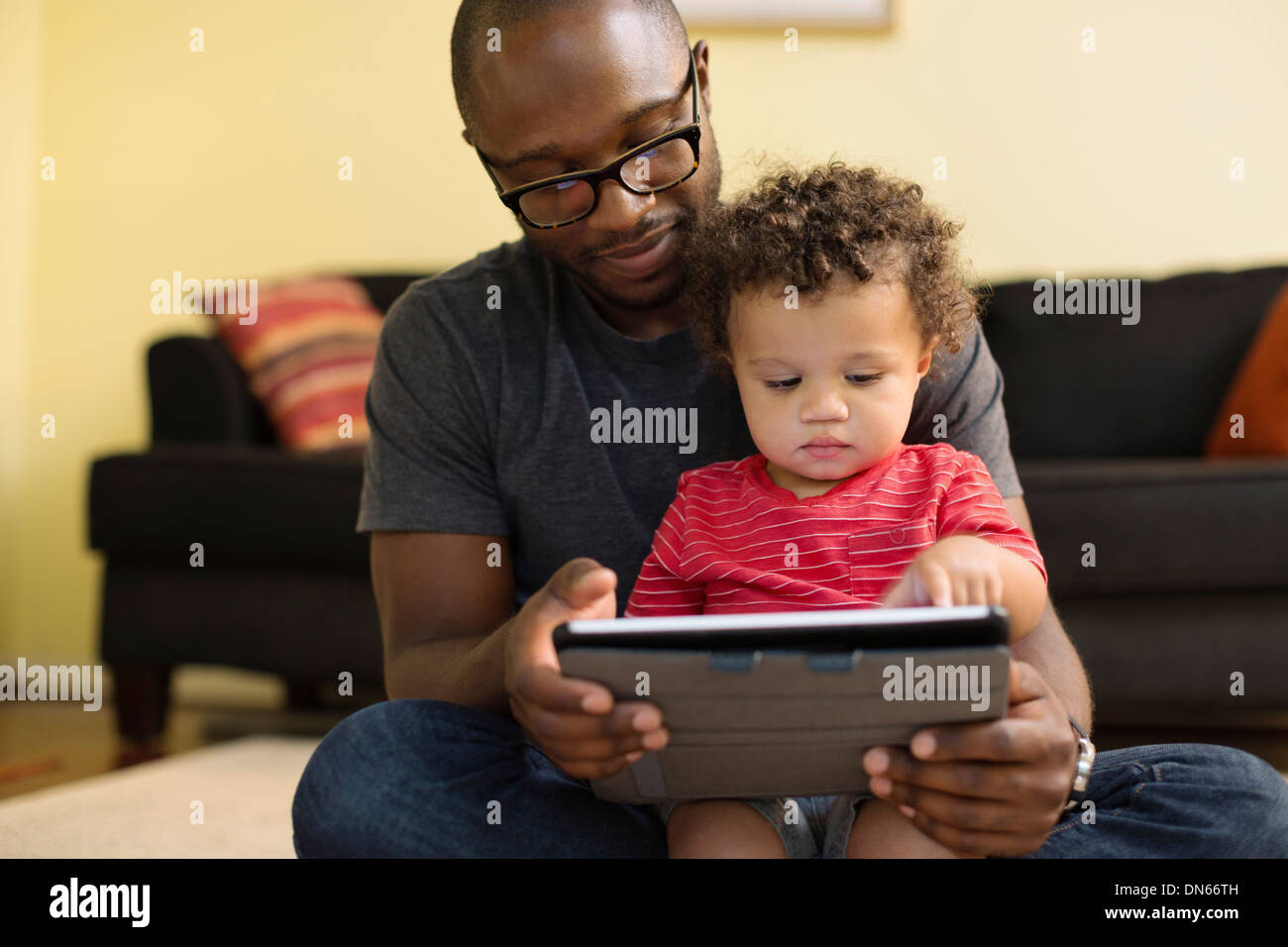 Father and toddler using digital tablet Stock Photo - Alamy
