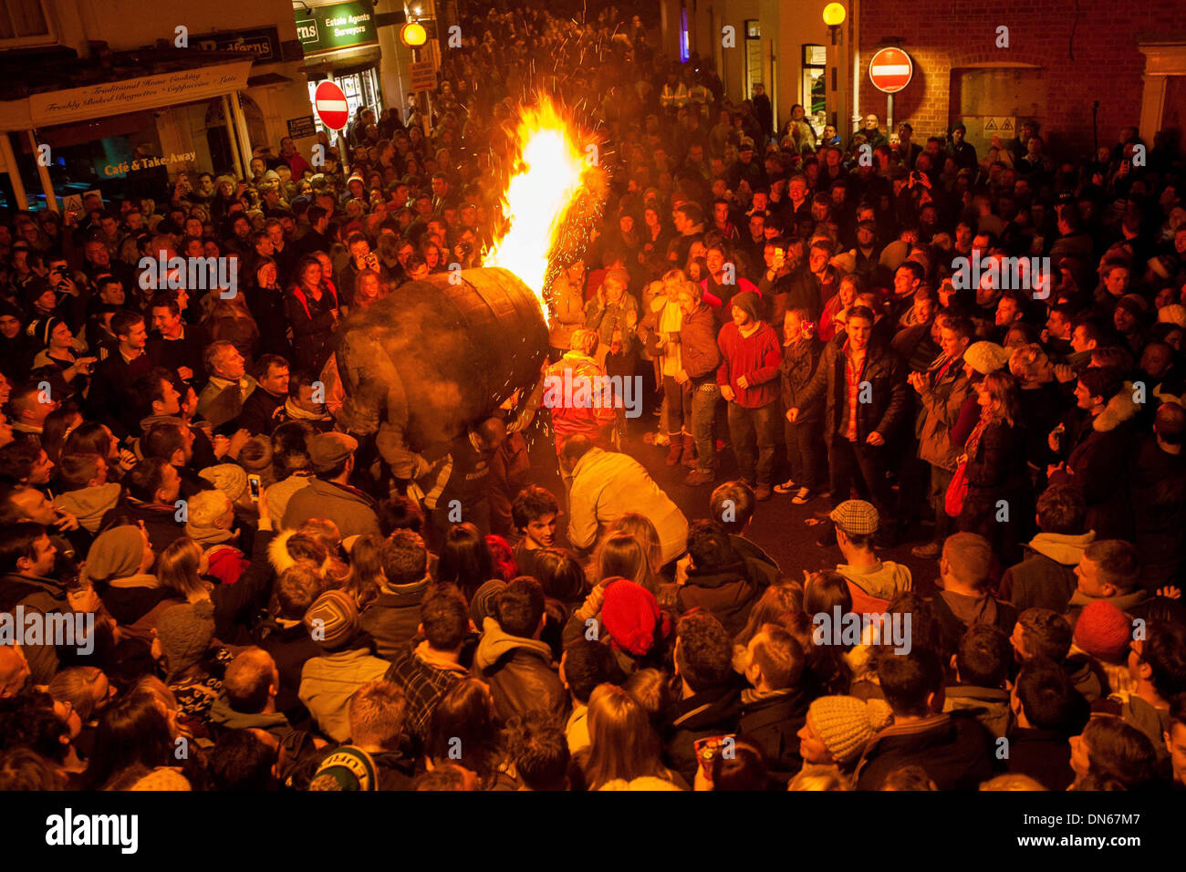 Participants run with a burning tar barrel through the streets of ...