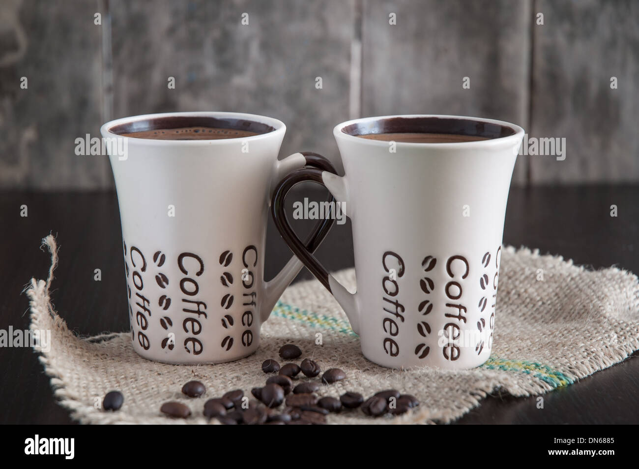 two modern espresso cups on a wooden table Stock Photo - Alamy