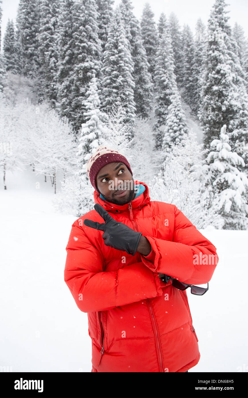 African American Cheerful black man in ski suit in snowy winter ...