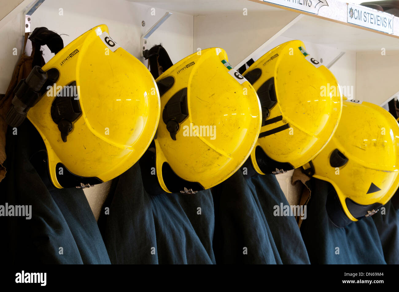 Firemen`s helmets and clothing hung up, Henley-in-Arden fire station ...
