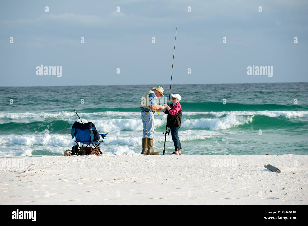 Elderly couple standing on beach hi-res stock photography and images ...
