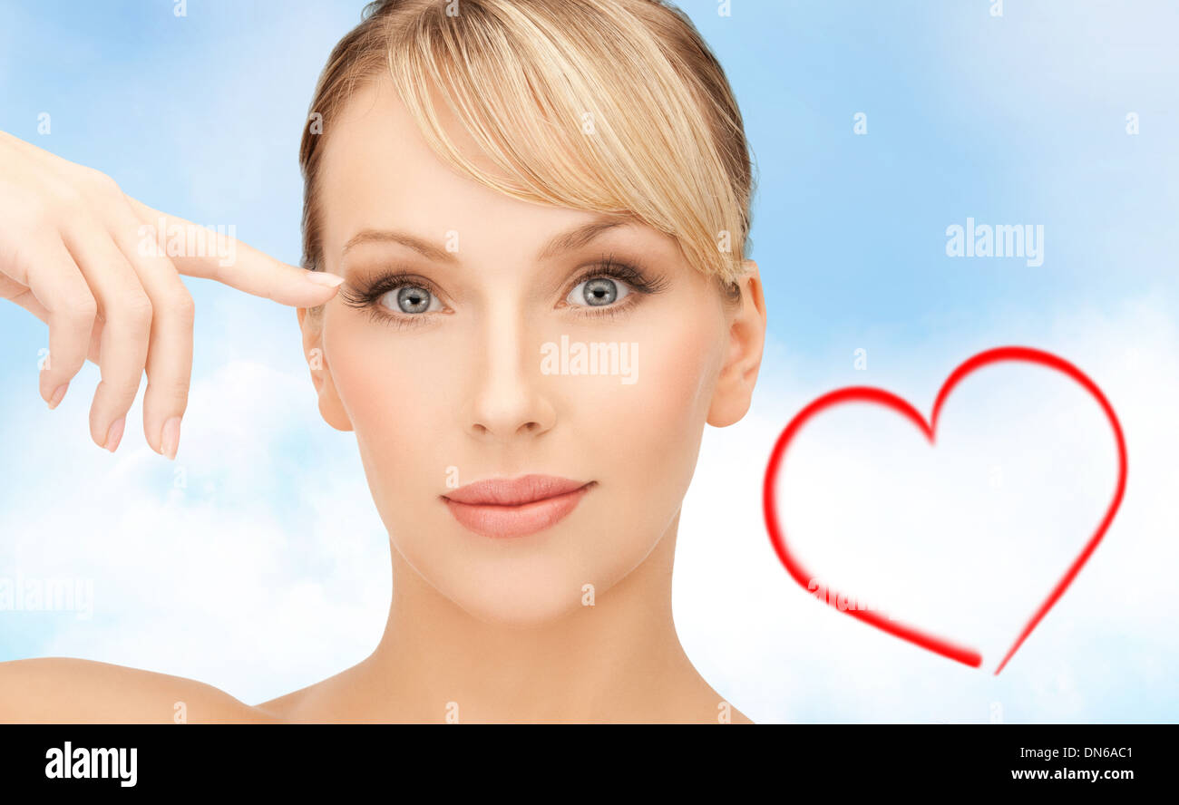 beautiful woman touching her eye area Stock Photo - Alamy