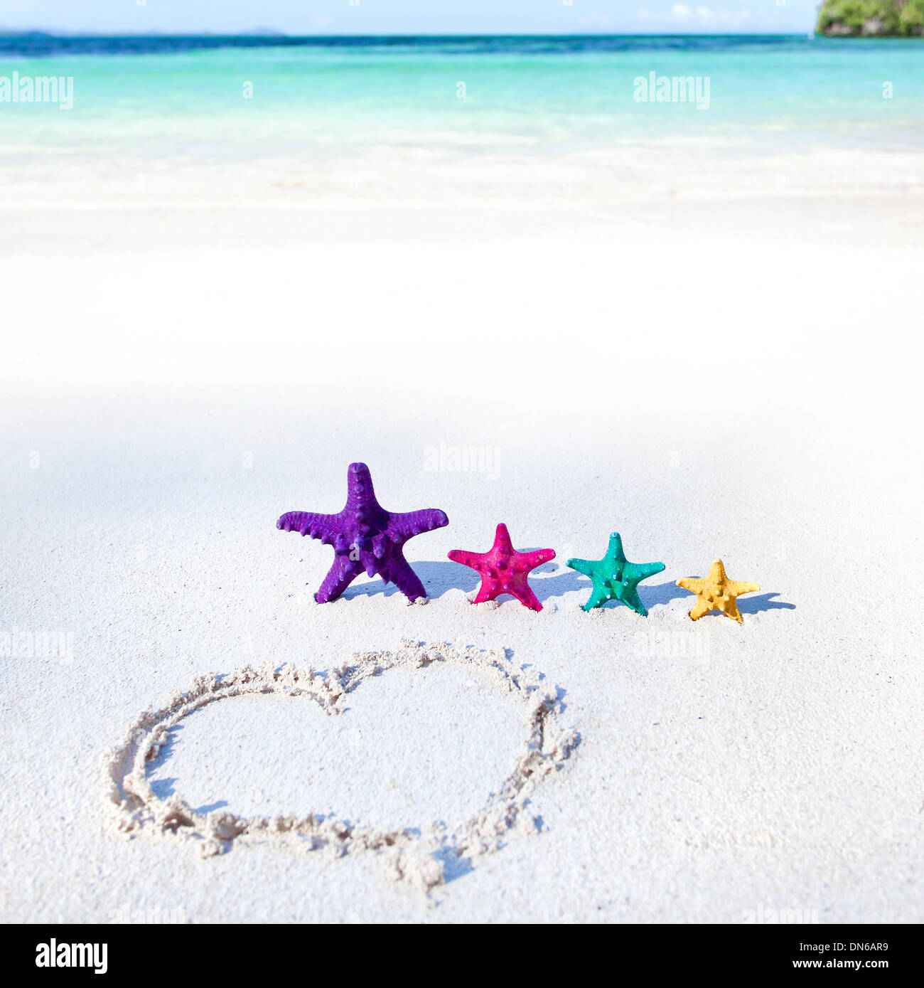 Heart on beach with color starfishes, romantic concept Stock Photo - Alamy