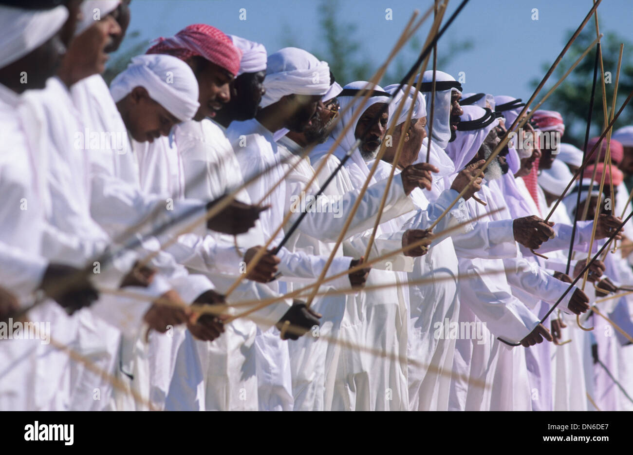 UAE, Abu Dhabi, men in traditional dance along the corniche, at one of ...