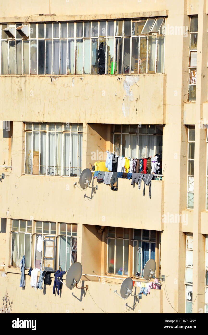 Drying laundry hanging on the dilapidated balconies of a block of flats ...