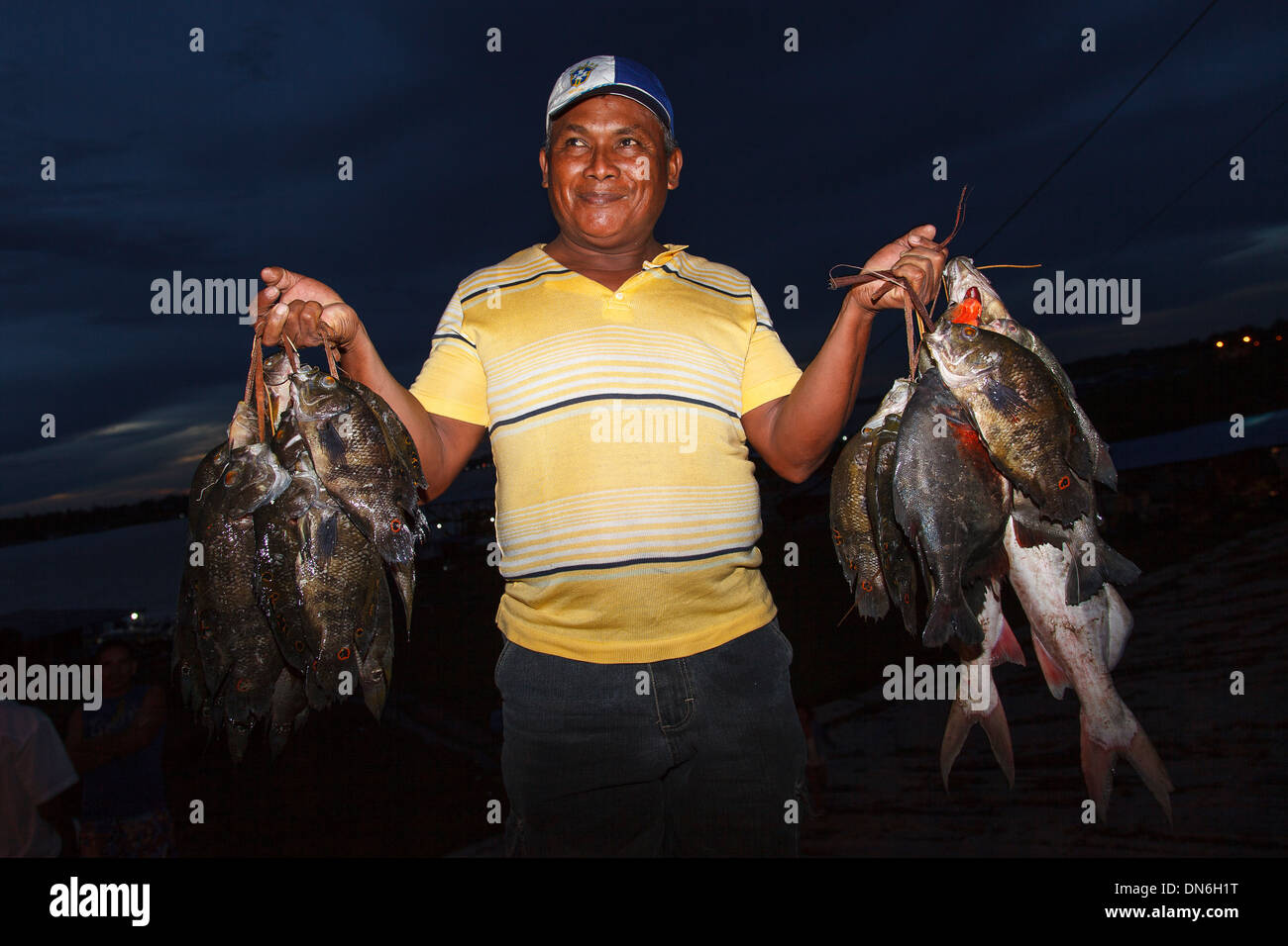 Fisherman with fish in Tabatinga port. Amazonas river (Brazil Stock ...