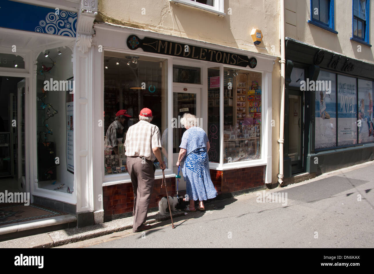Old Couple People looking in shop window Fowey Cornwall UK Stock Photo ...