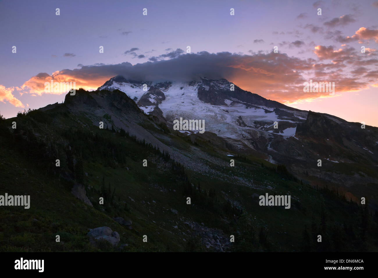WASHINGTON - Sunrise over a cloud cap covered summit of Mount Rainier ...