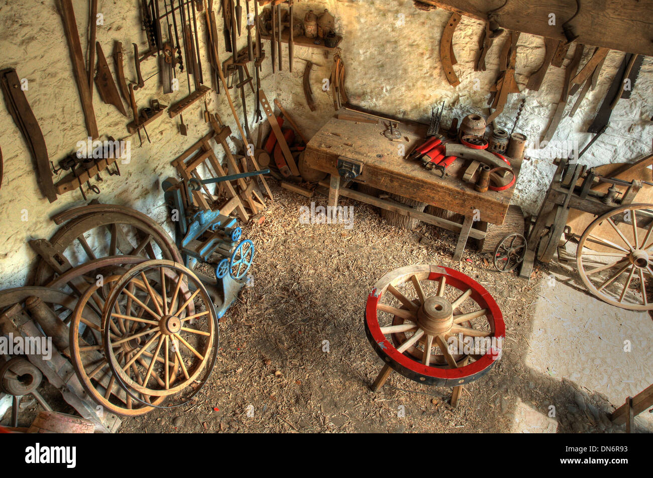 Traditional wheelwrights workshop with tools and cartwheels, England ...