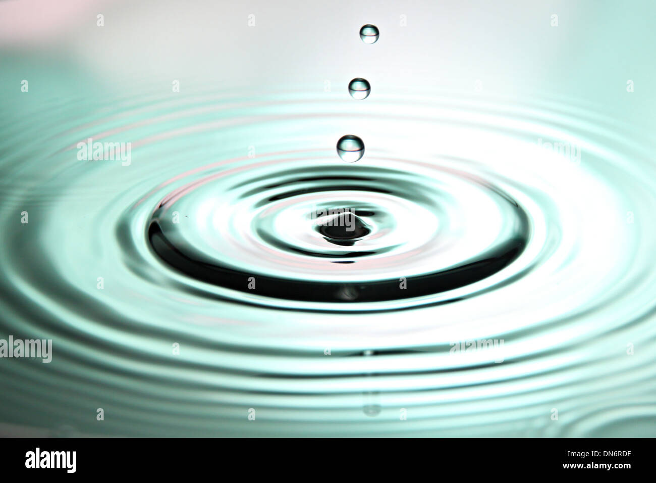 Water drops cause the shape on green background Stock Photo - Alamy