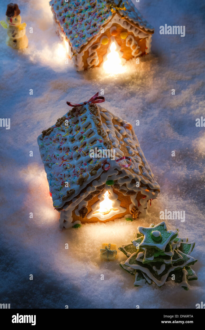 Gingerbread cottage with snow and Christmas tree Stock Photo - Alamy