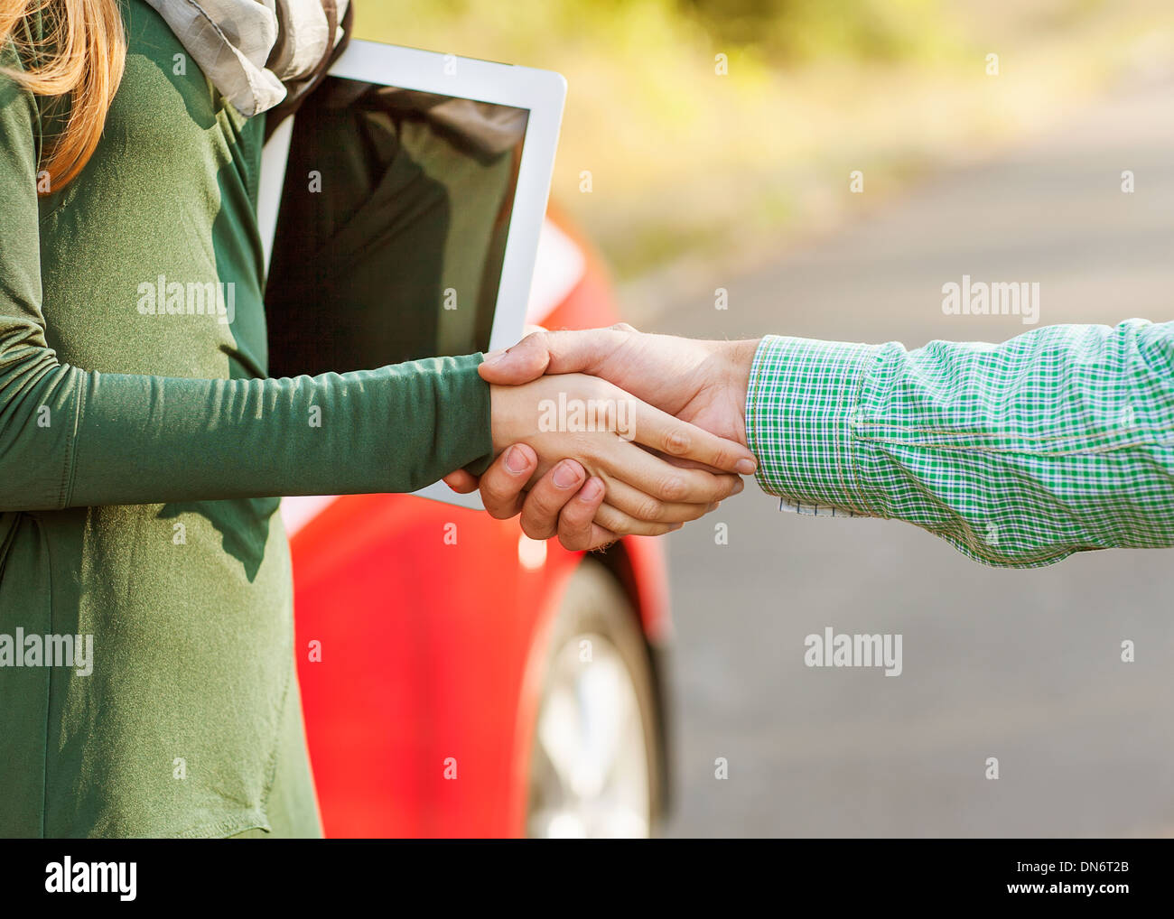 Business handshake to close the deal after buying a car, between a man ...